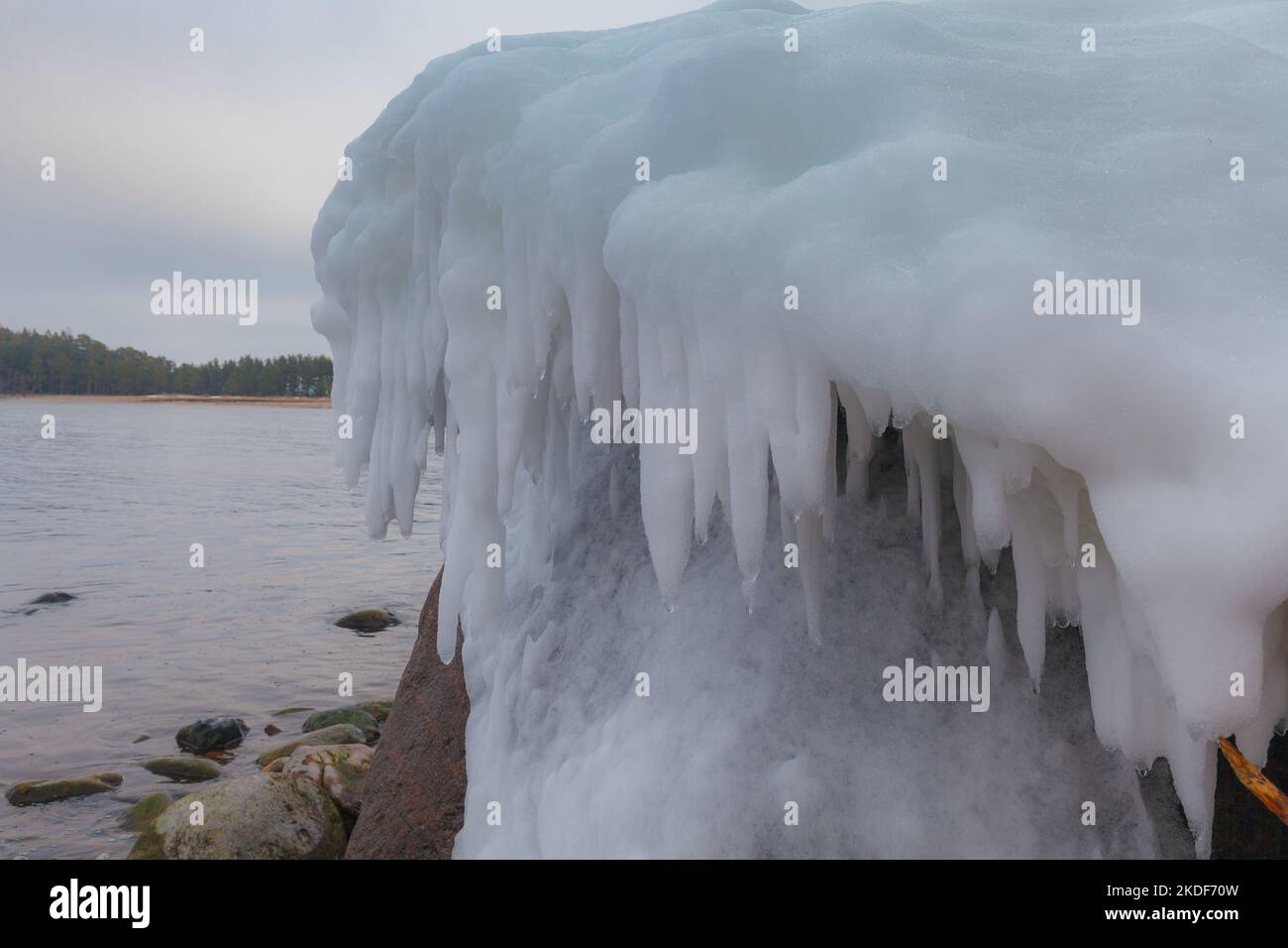 Winter by the sea. Ice-covered boulder. Ice on the sea Stock Photo - Alamy