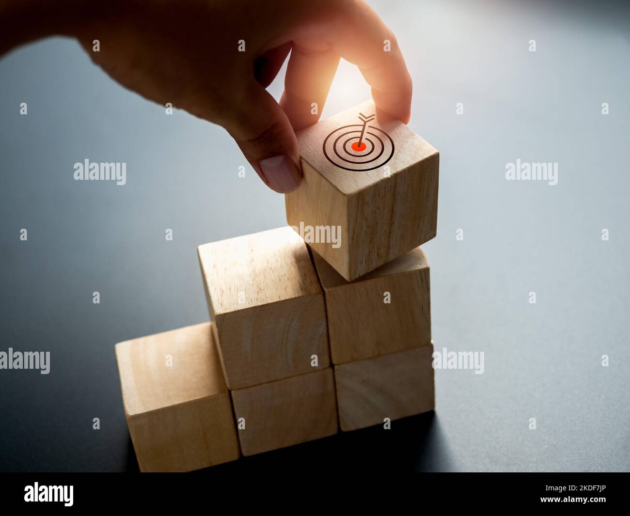 Close Up Target icon on the top of wooden cube block graph chart step ...