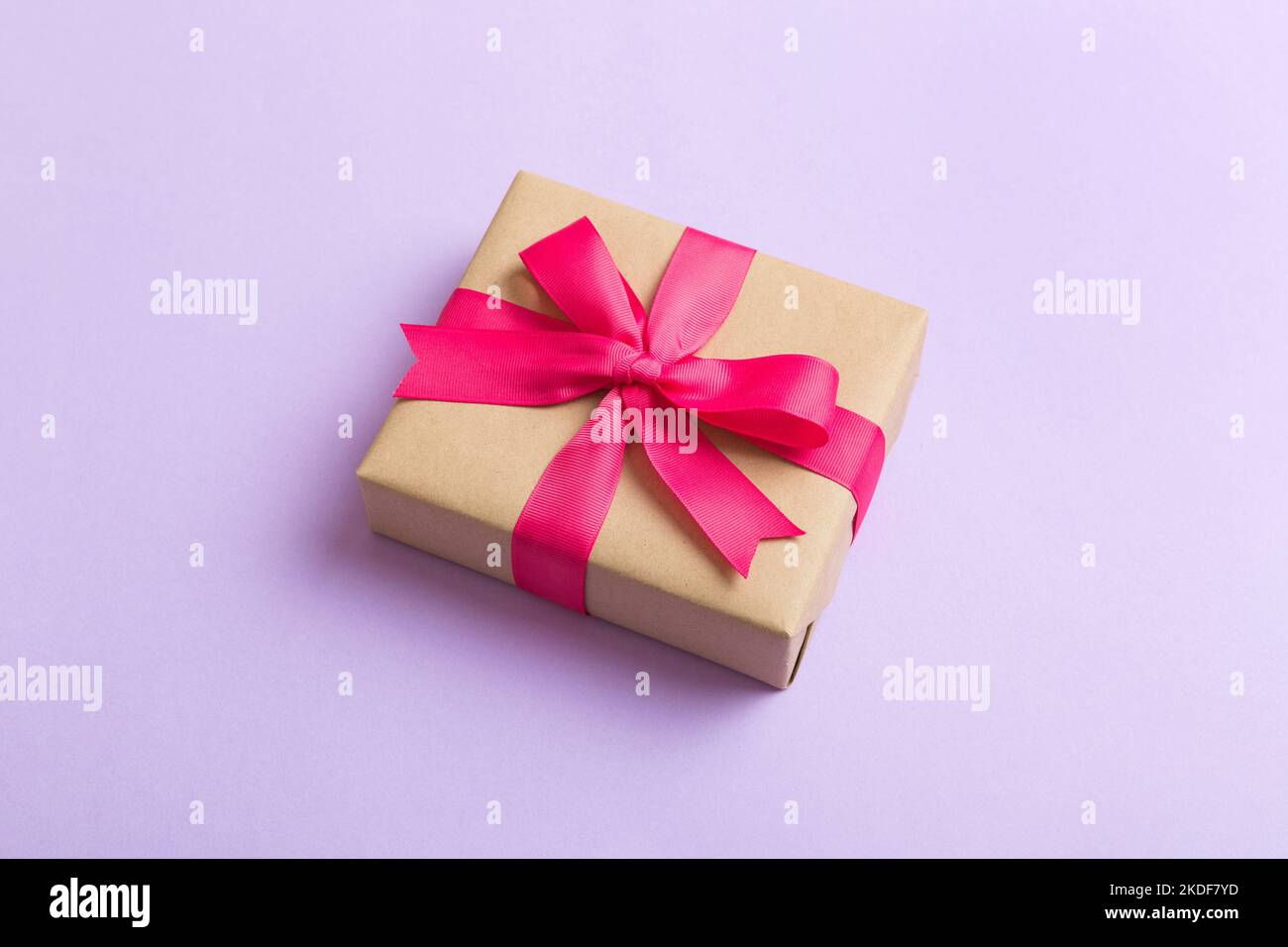 Wrapped christmas or other holiday handmade present in craft paper with ...