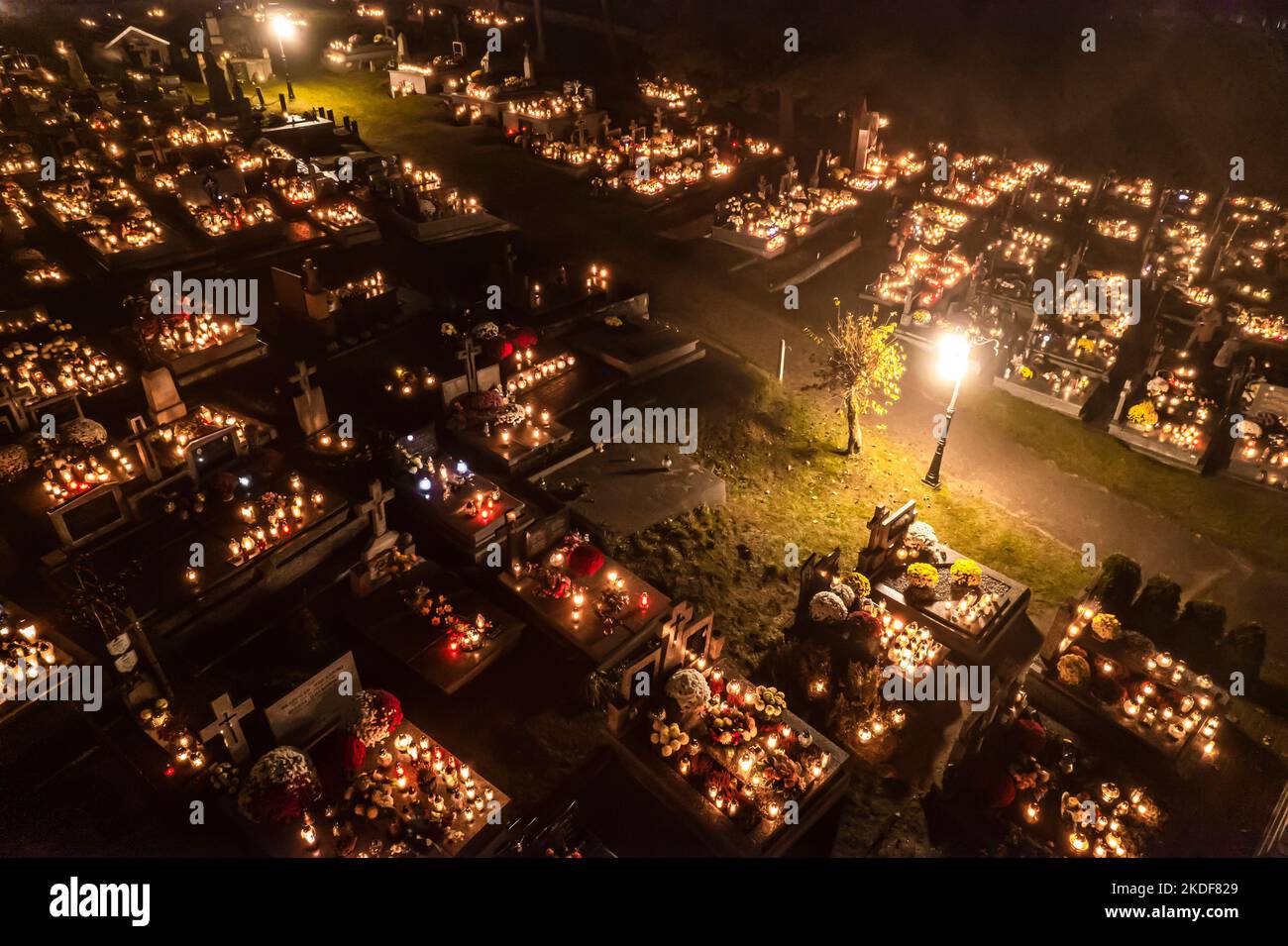 Atmospheric drone aerial view of beautifully illuminated graves in ...