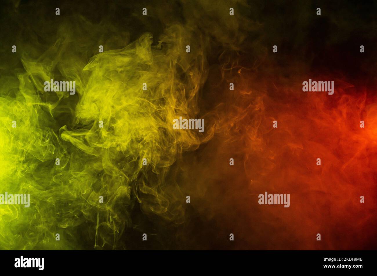 Red-yellow smoke spreads on a black background Stock Photo - Alamy