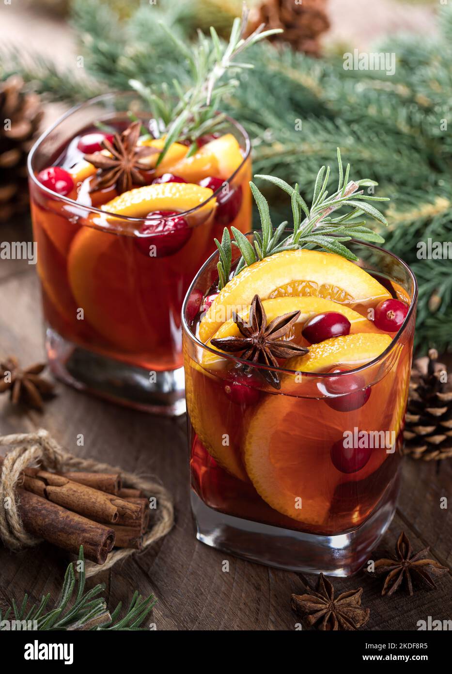 Mulled wine with orange slices, cranberries and spices on rustic wooden ...