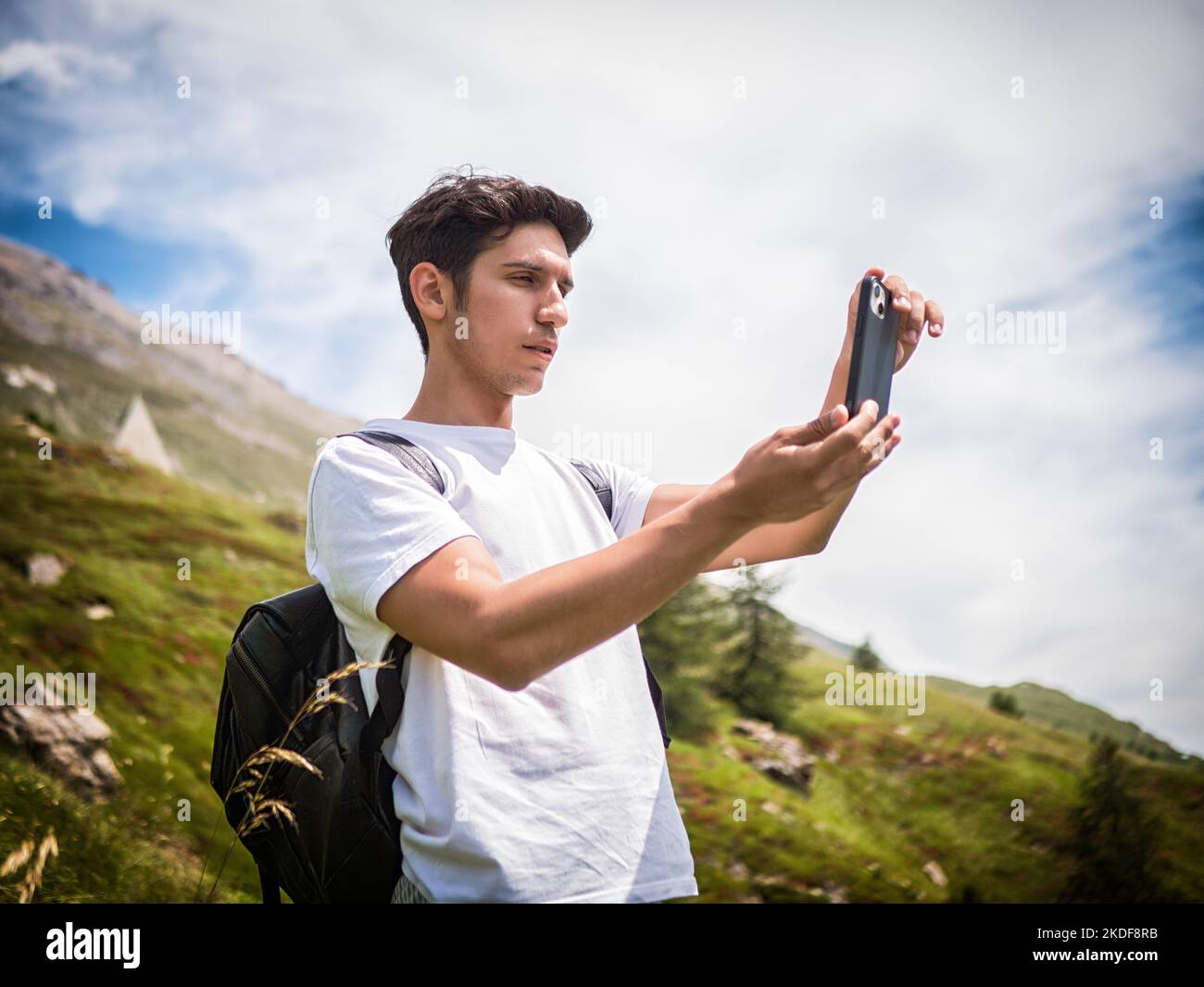 Young Man Taking Photo With Cell Phone in Mountains Stock Photo - Alamy