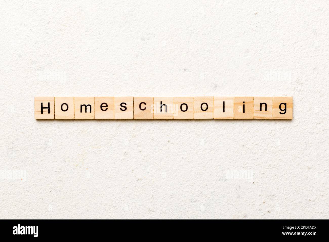 Homeschooling word written on wood block. Homeschooling text on cement ...