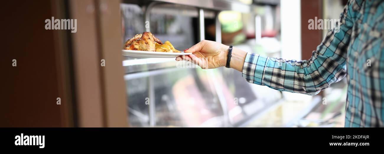 Woman taking plate with lunch in canteen Stock Photo - Alamy
