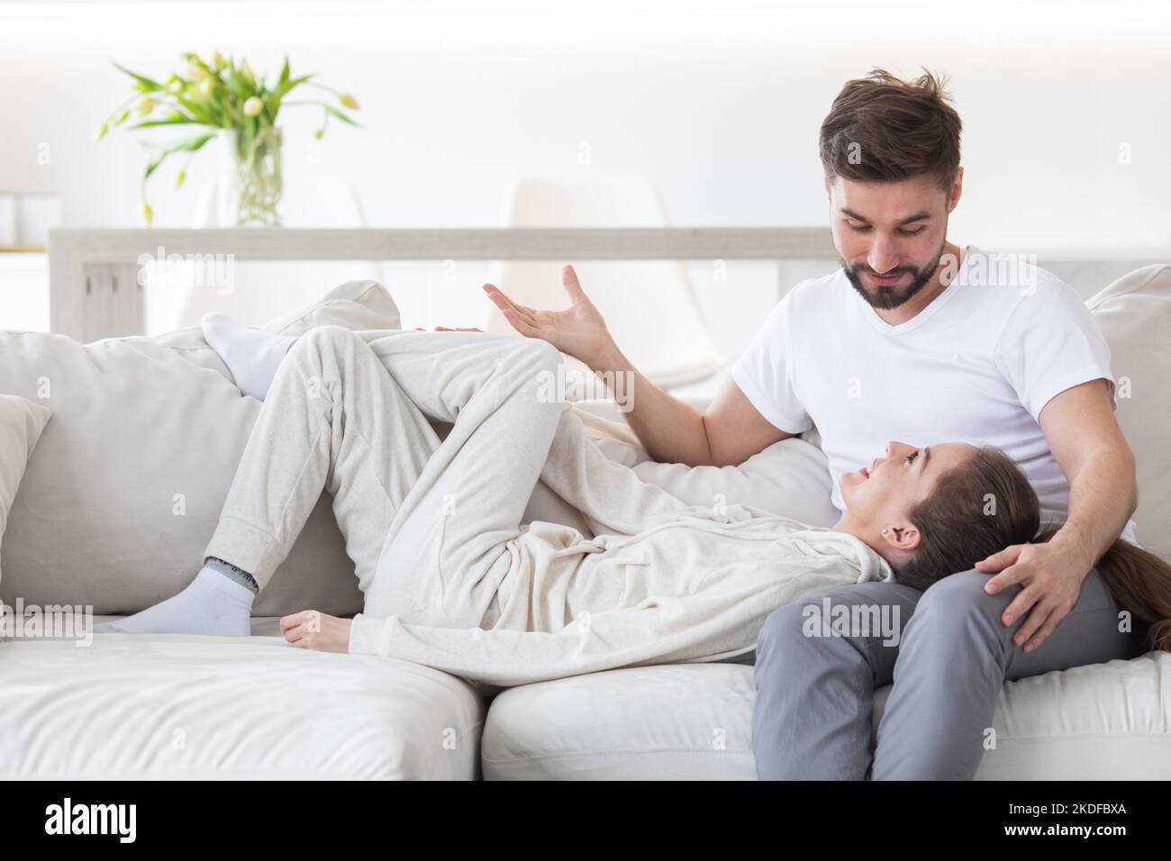 Woman lay head on boyfriend lap looking in each other eyes smile ...