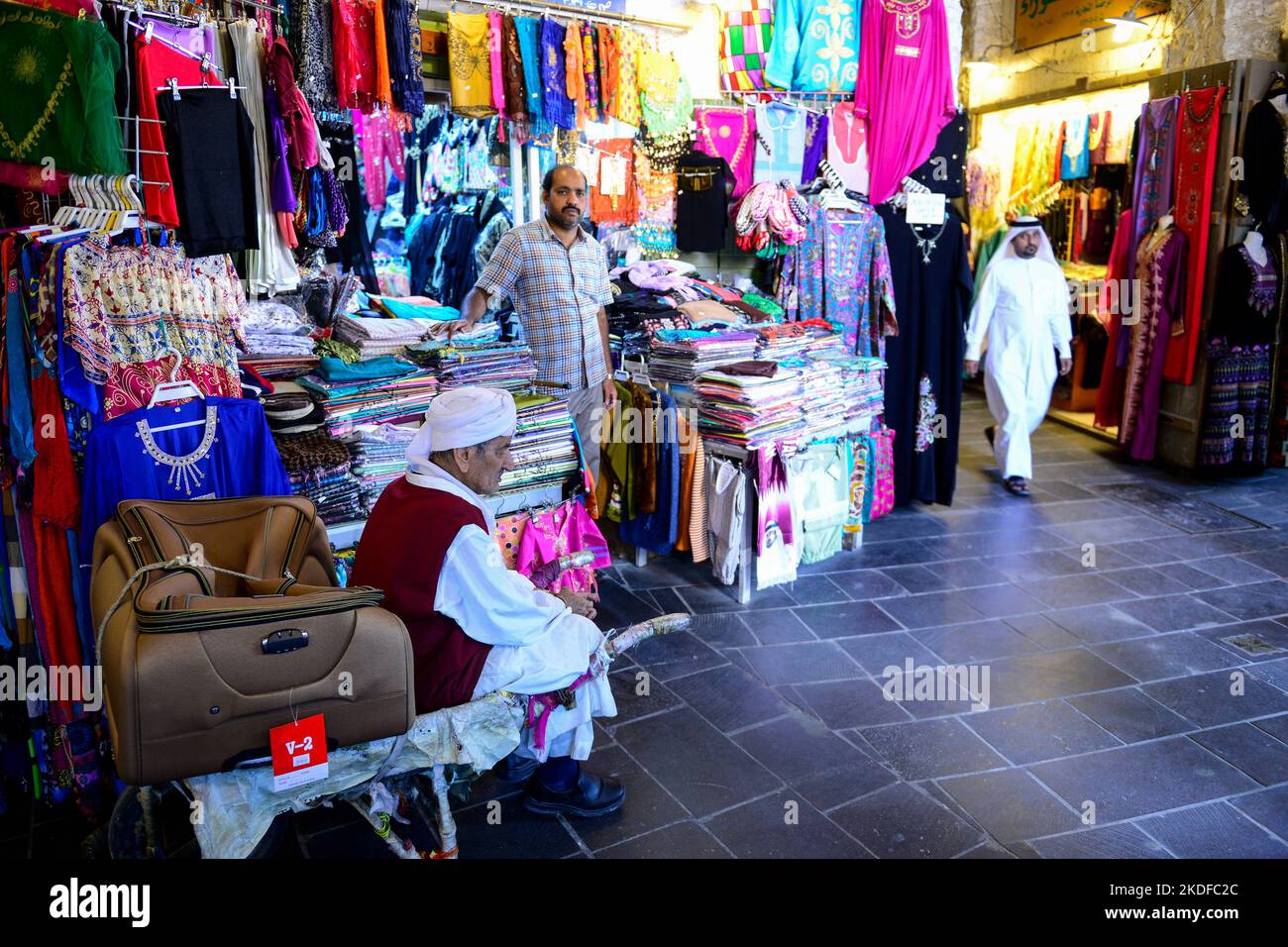 QATAR, Doha, Bazar Souq Waqif, textile shop, migrant worker works as ...