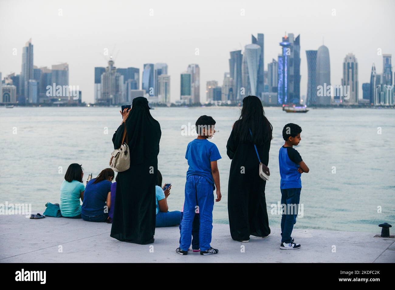QATAR, Doha, eastbay skyline with skyscraper, standing qatari women ...
