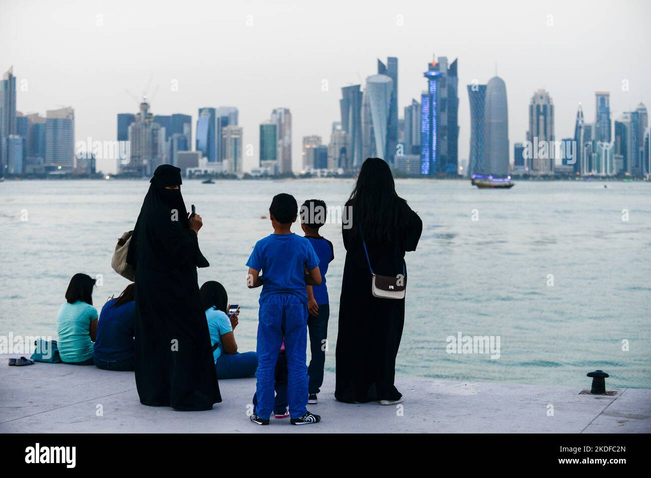 QATAR, Doha, eastbay skyline with skyscraper, standing qatari women ...