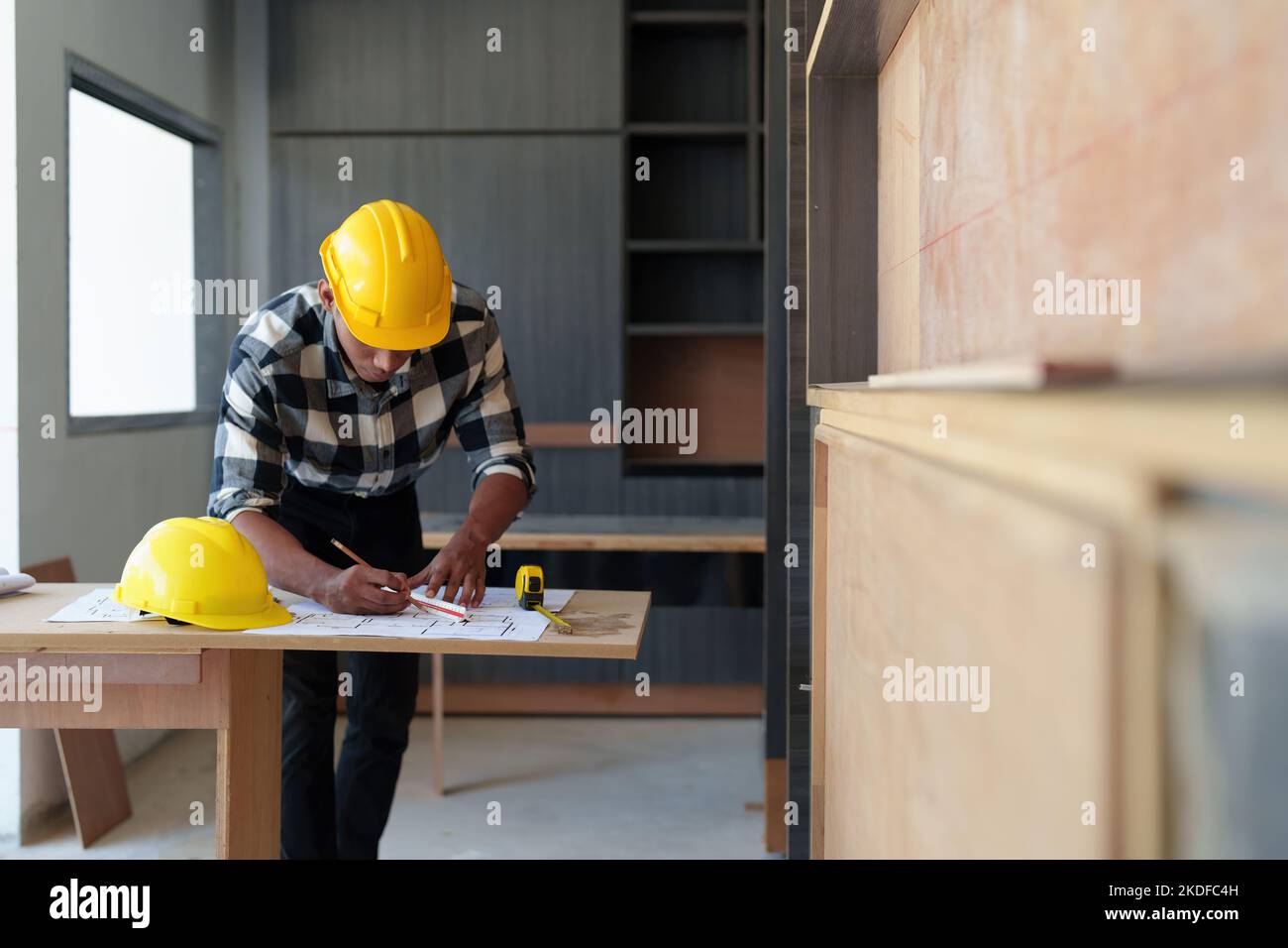 Architect man working with blueprints for architectural plan, engineer ...