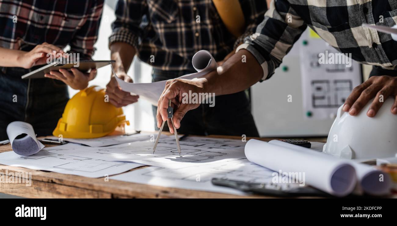 Architect team working with blueprints for architectural plan, engineer ...