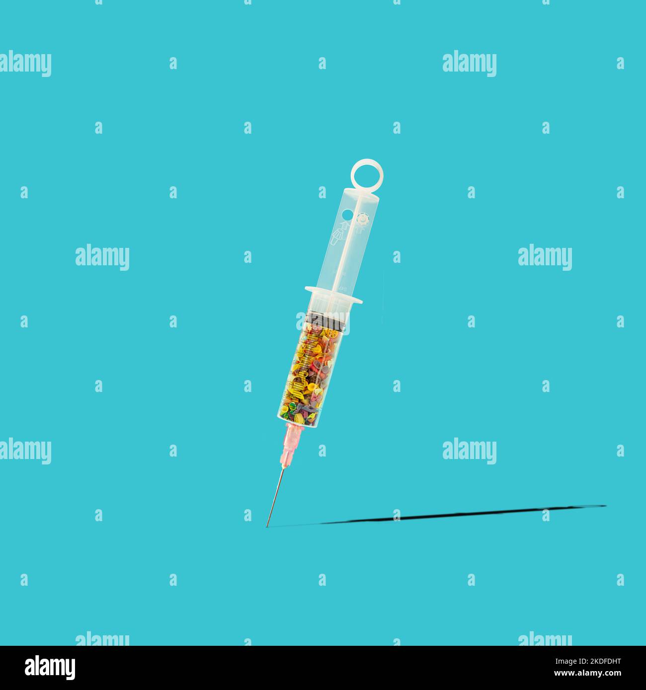 Various and colorful pasta in a medical syringe with a needle on the ...