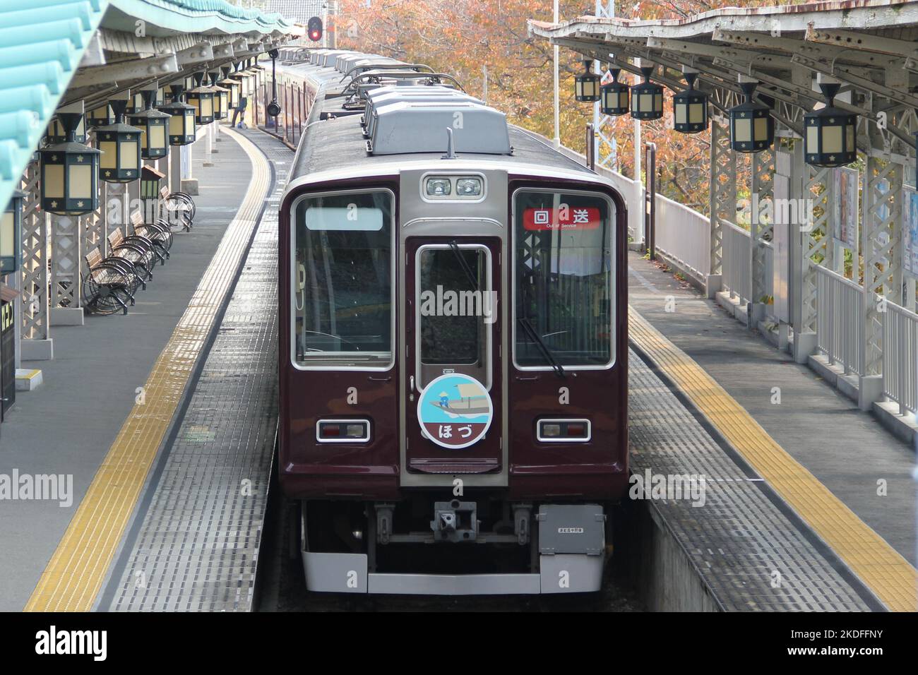 A high angle shot of the Hankyu Railway train at the Arashiyama Station ...