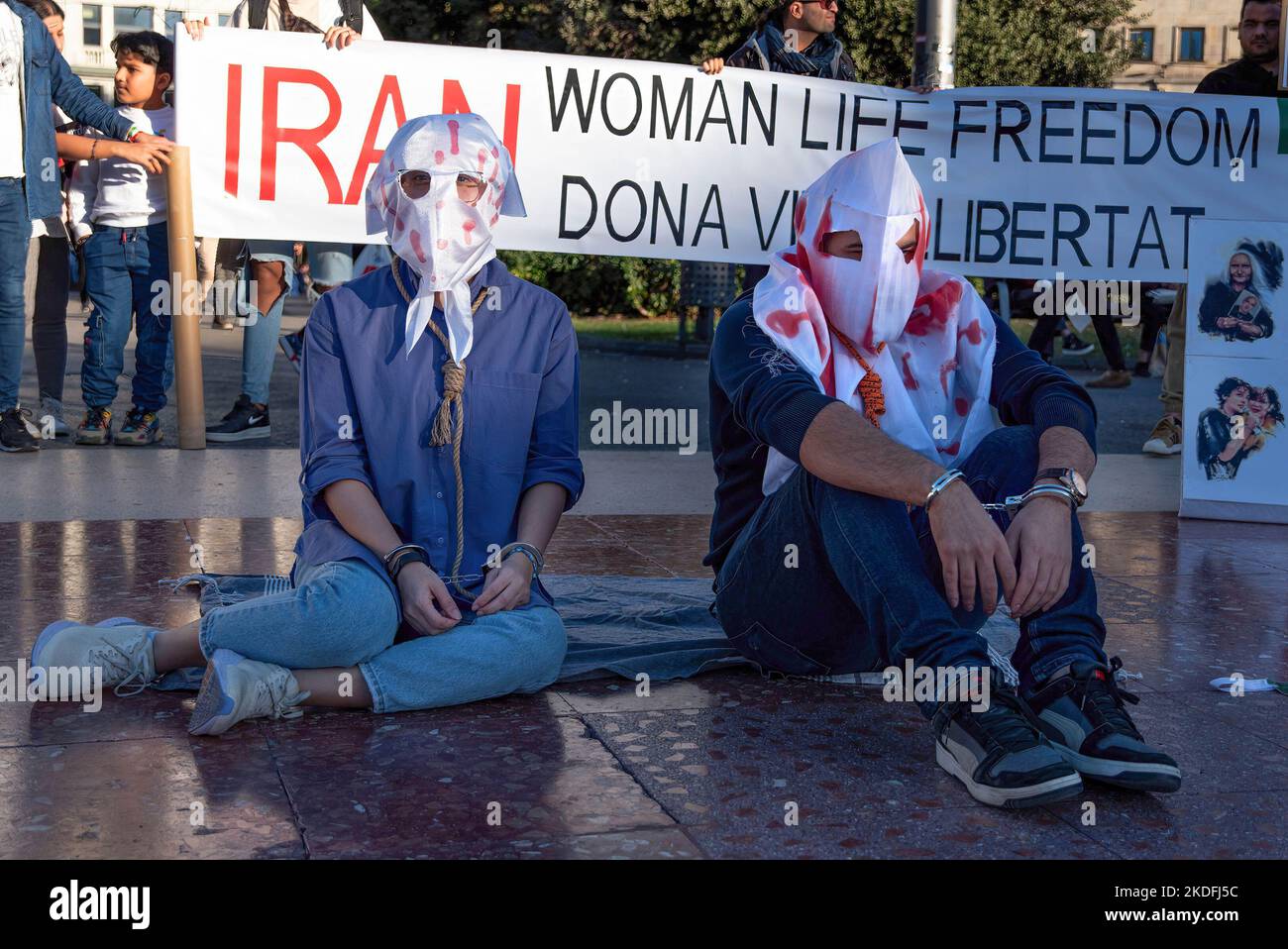 Protesters seen wearing masks and handcuffs as a symbol of repression ...