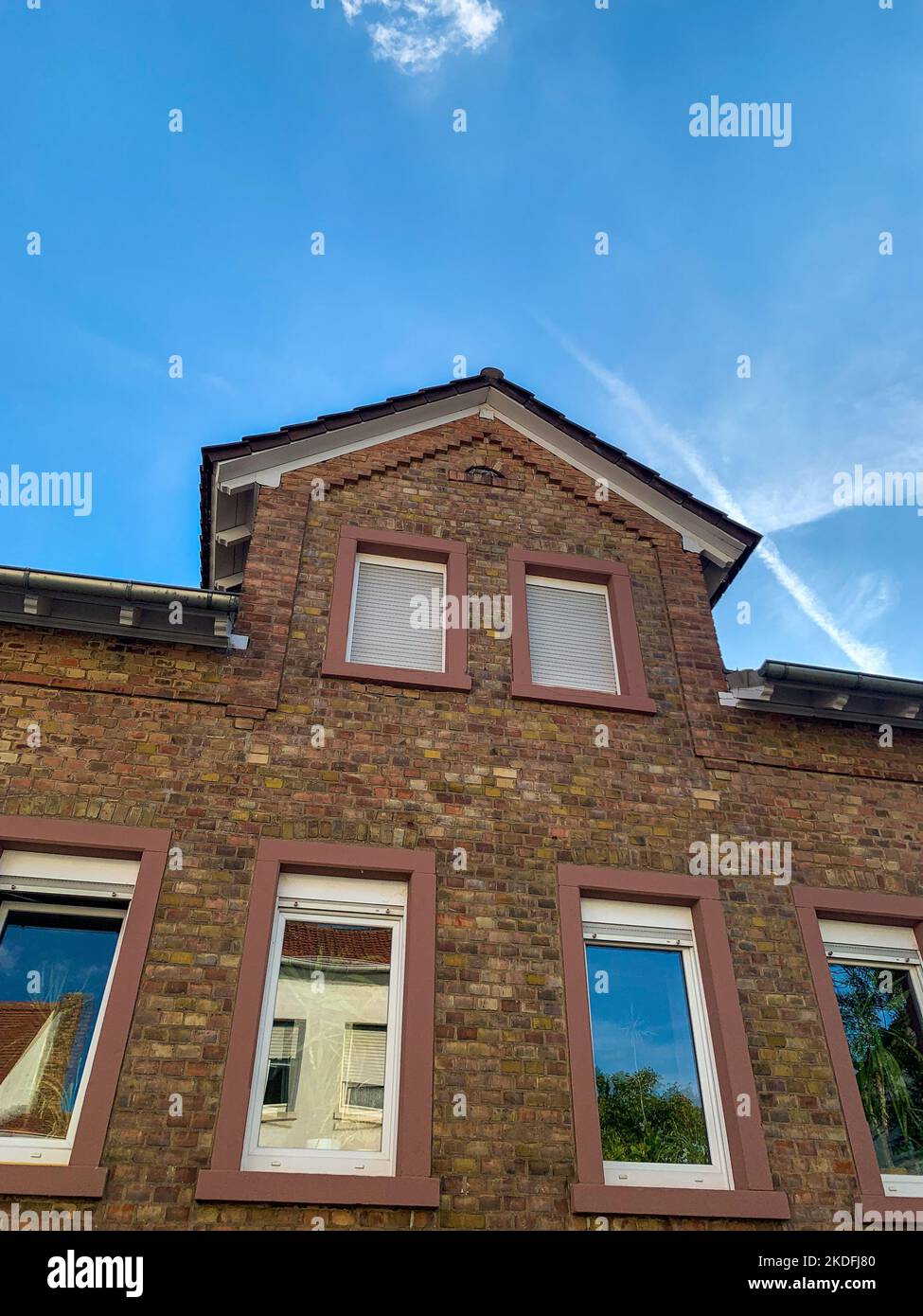 A vertical shot of a house with window shutters in Muhlheim am Main on ...
