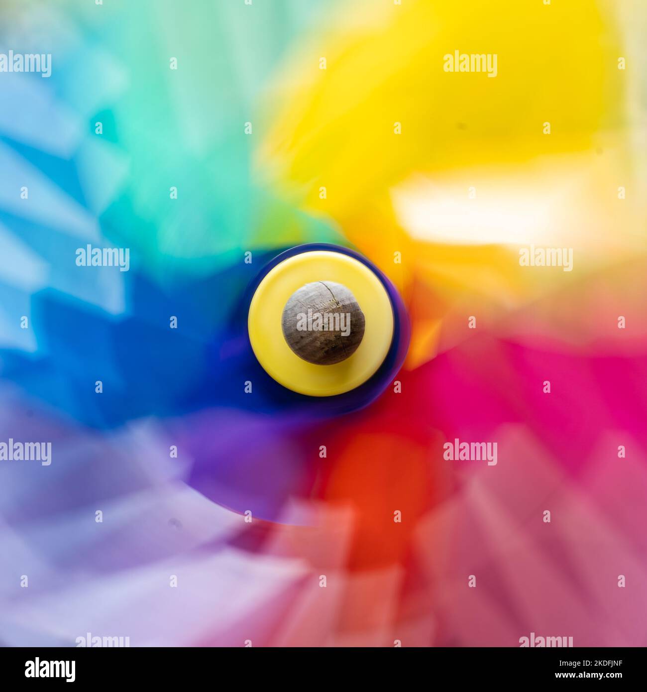 A closeup shot of details on a spinning plastic rainbow pinwheel Stock ...