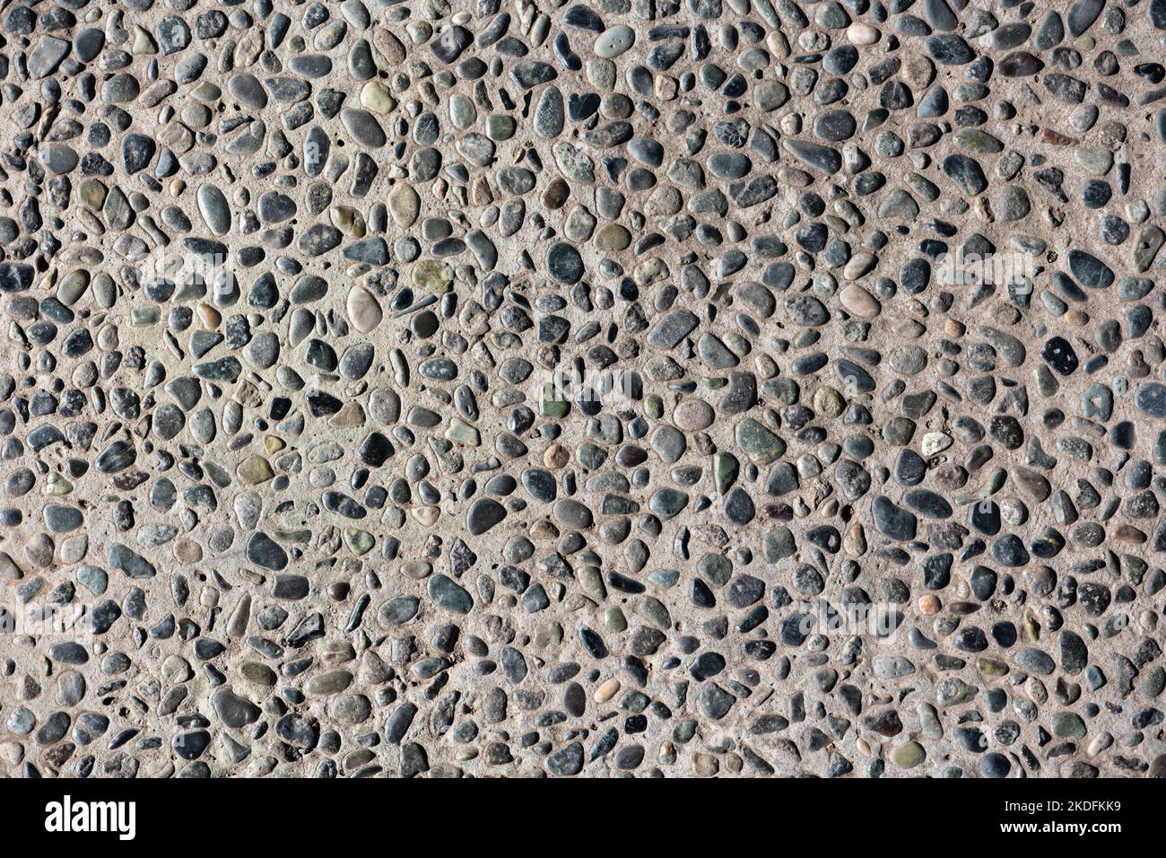 Pebbles in concrete texture or background Stock Photo - Alamy