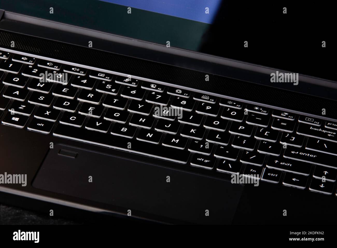 A closeup of a black computer keyboard with white letters and numbers ...