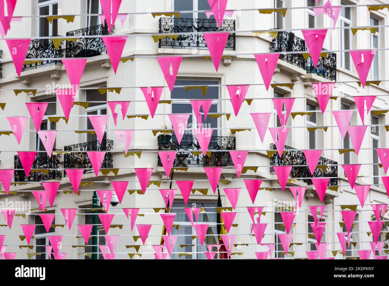 Small pink pennants, mostly torn, decorating a street in Brussels ...