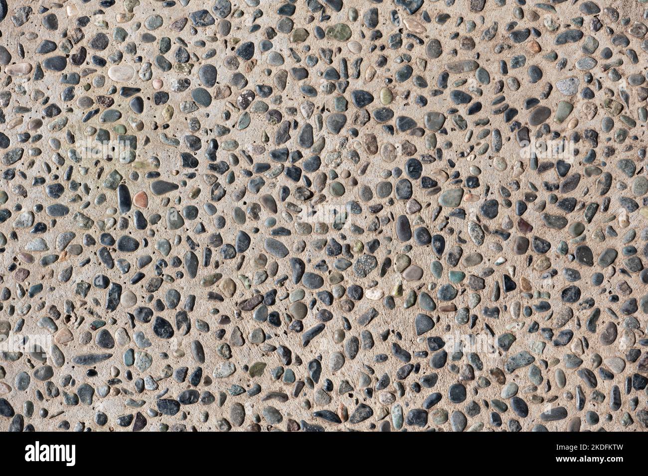 Pebbles in concrete texture or background Stock Photo - Alamy