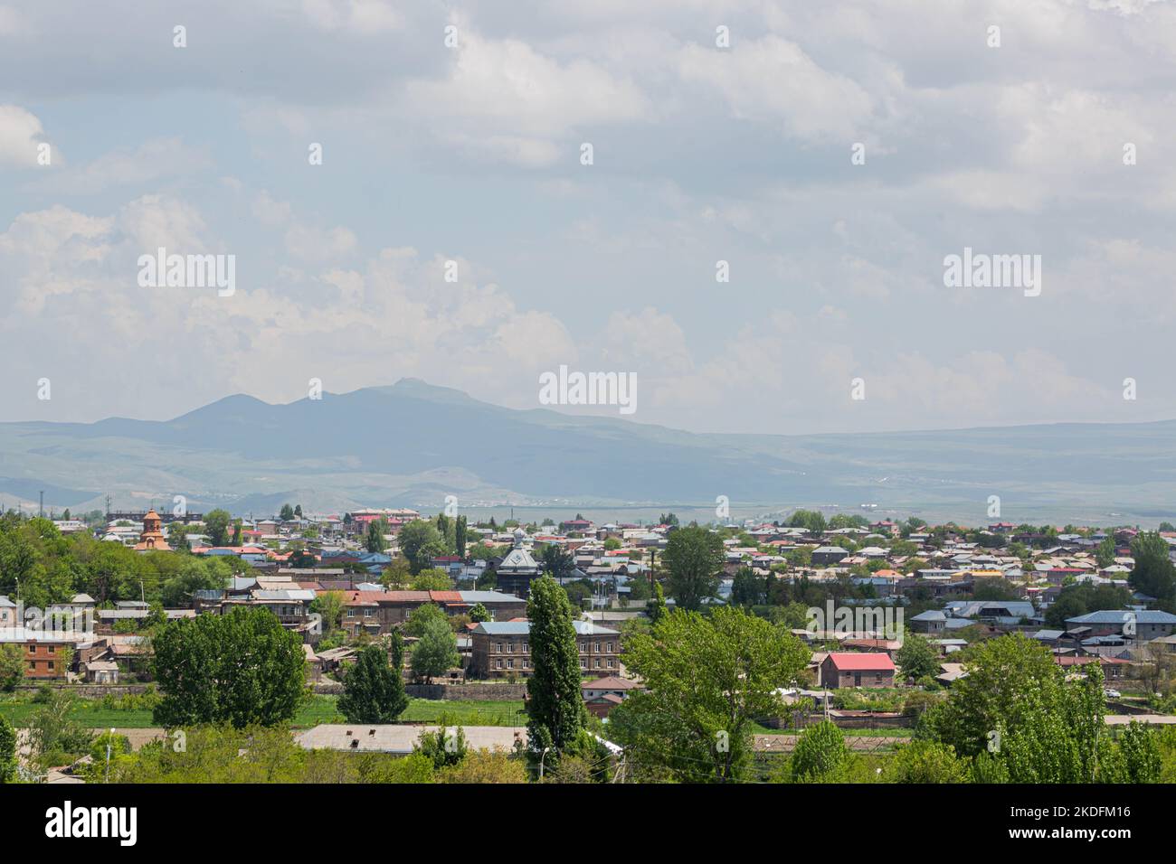 The beautiful skyline, trees, and nearby mountains in the historic city ...