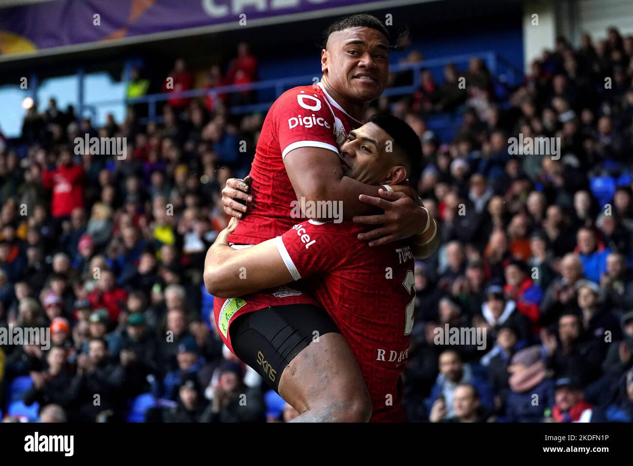 Tonga's Daniel Tupou (right) celebrates scoring his side's first try of ...