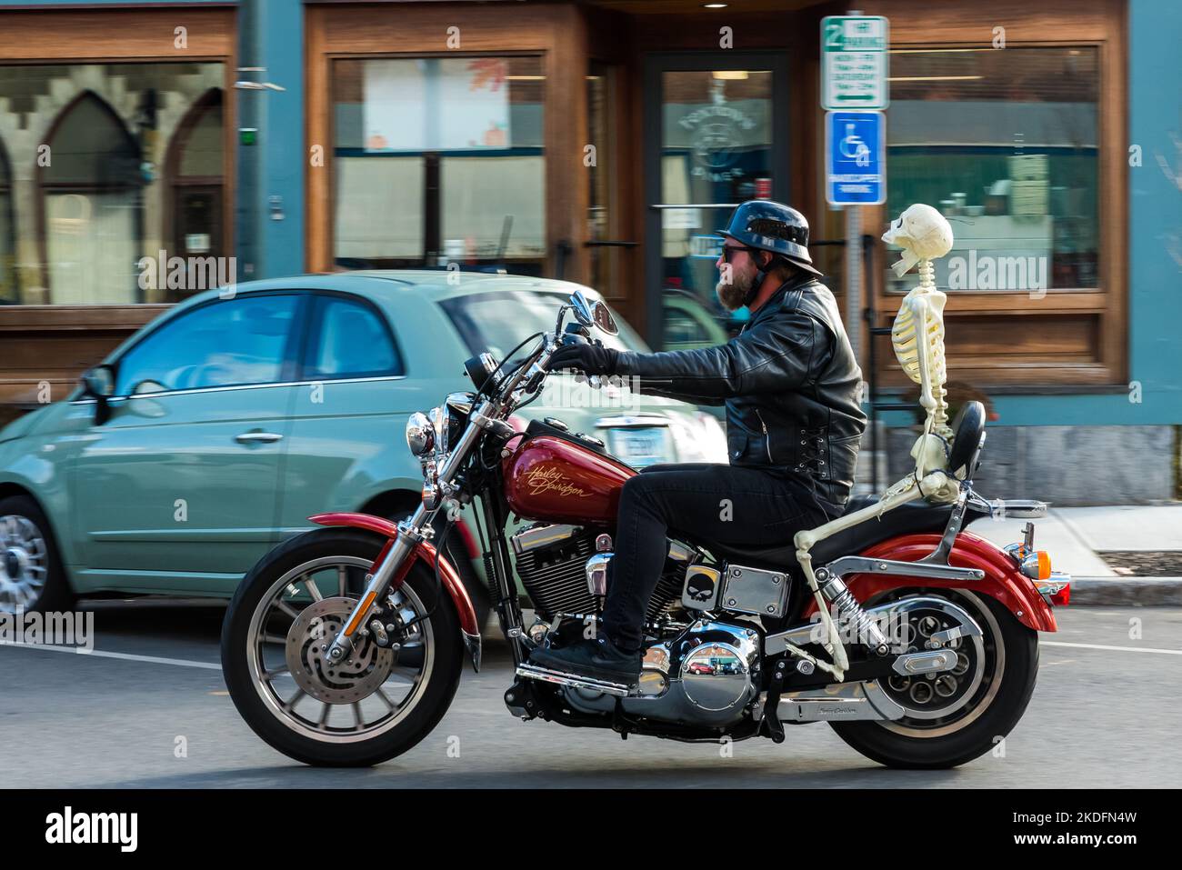 Riding a Harley with Death as his passenger Stock Photo - Alamy