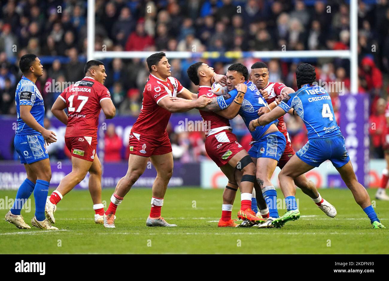 Tonga's Isaiya Katoa (centre) is tackled by Samoa's Jaydn Su'a during ...