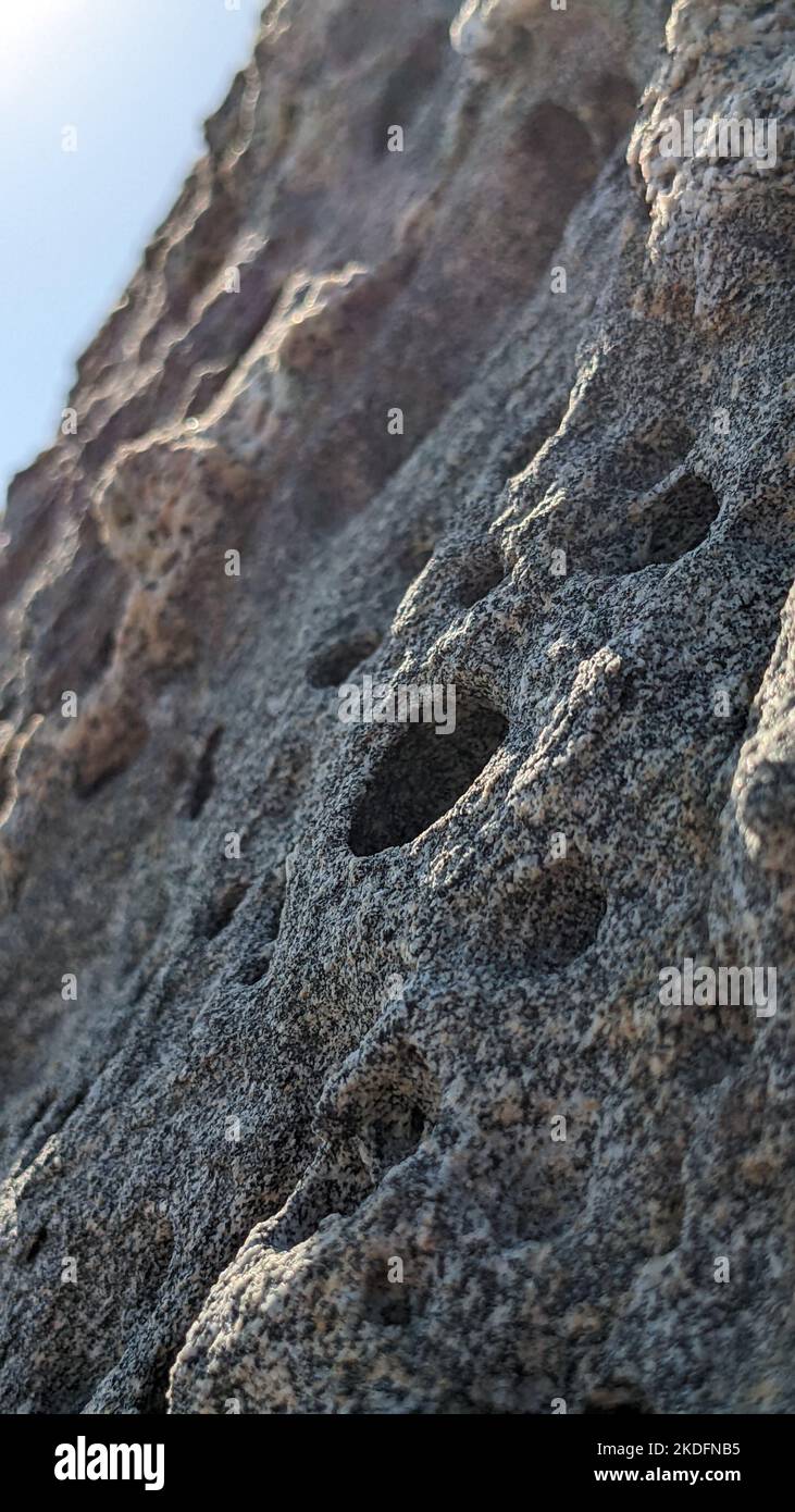 The natural geological rock formations with holes, in a vertical shot ...