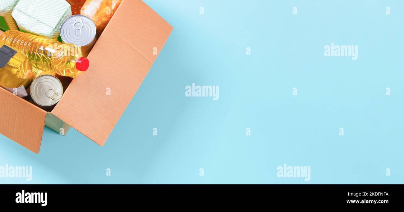 Cardboard box full of grocery products. Donation, charity, food bank ...