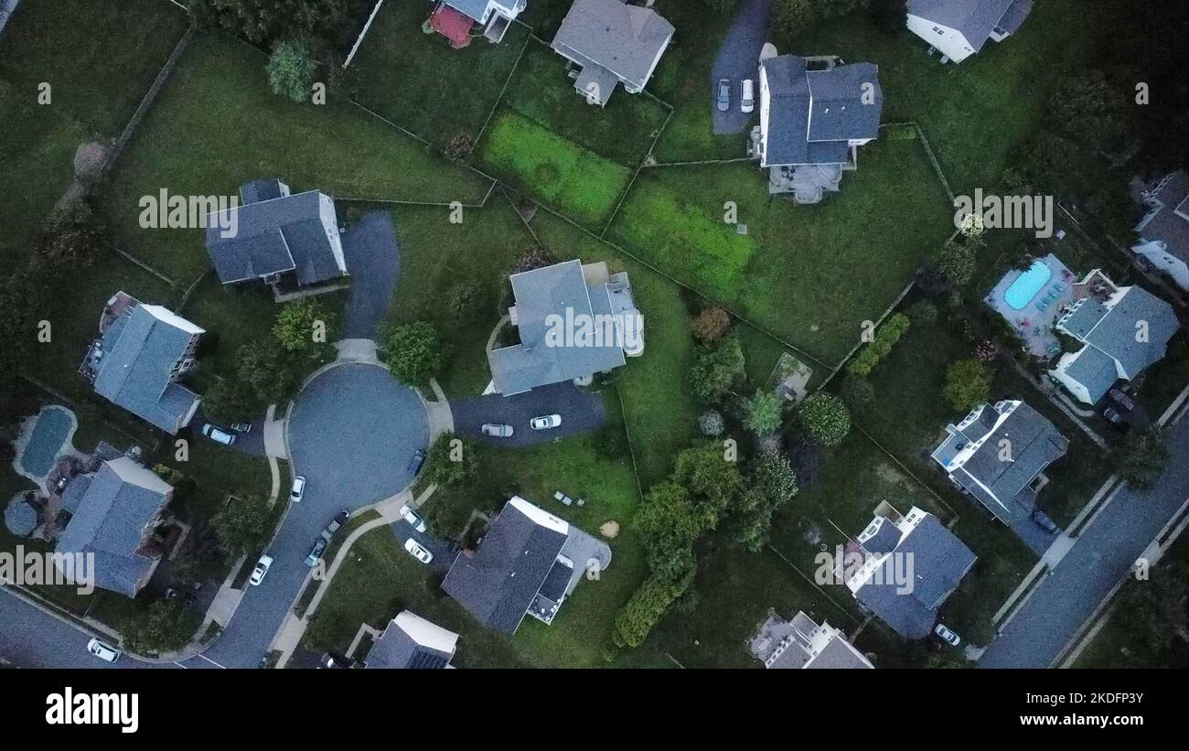 An aerial view of residential similar houses on green land in a ...