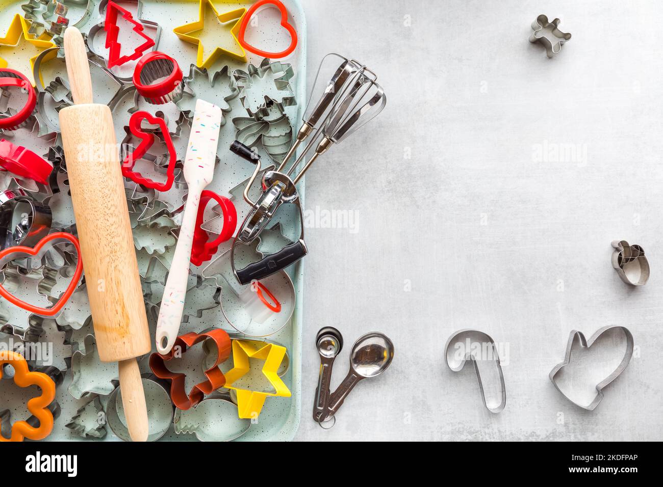 A baking tray filled with many cookie cutters and various other baking ...