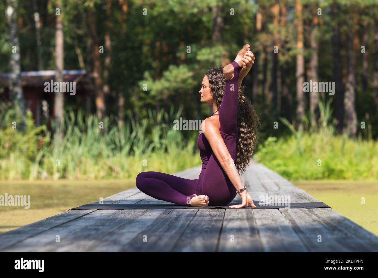 Woman leading a healthy lifestyle and practicing yoga, performs a ...