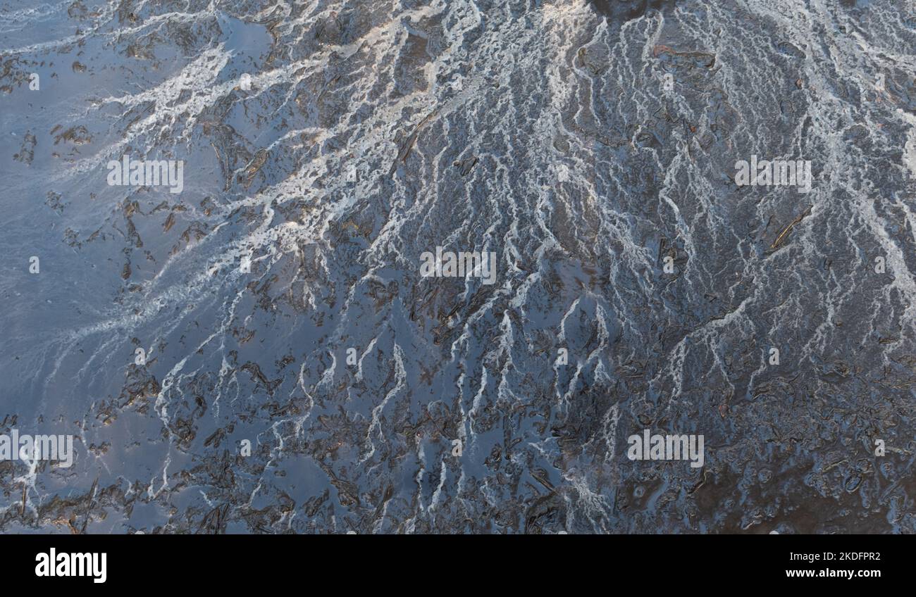Blurred image of mud stream in thick puddle close-up Stock Photo - Alamy