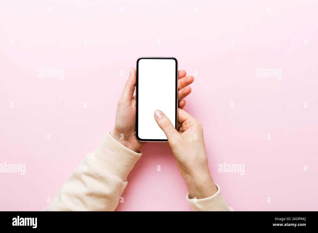 Top view of woman hands holding smart phone with blank copy space screen for your text message ...