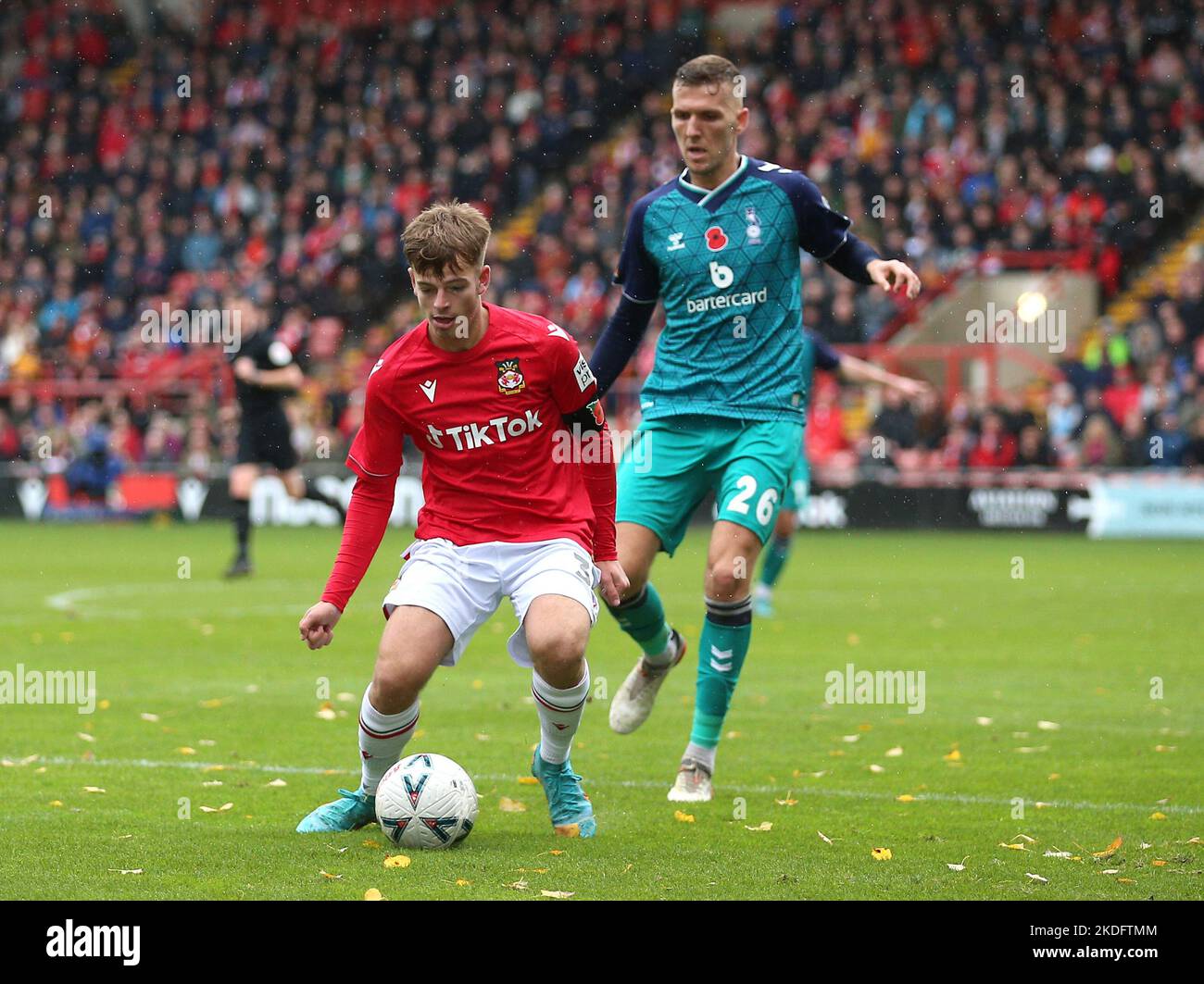 Wrexham’s Kai Evans (left) and Oldham Athletic’s Mark Kitching battle ...