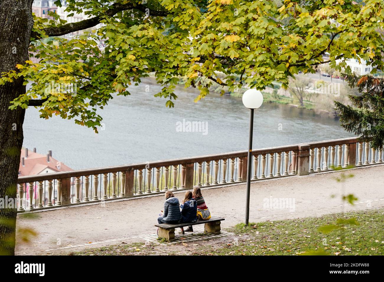 Heidelberg, Germany. 06th Nov, 2022. Three women sit on a park bench in ...