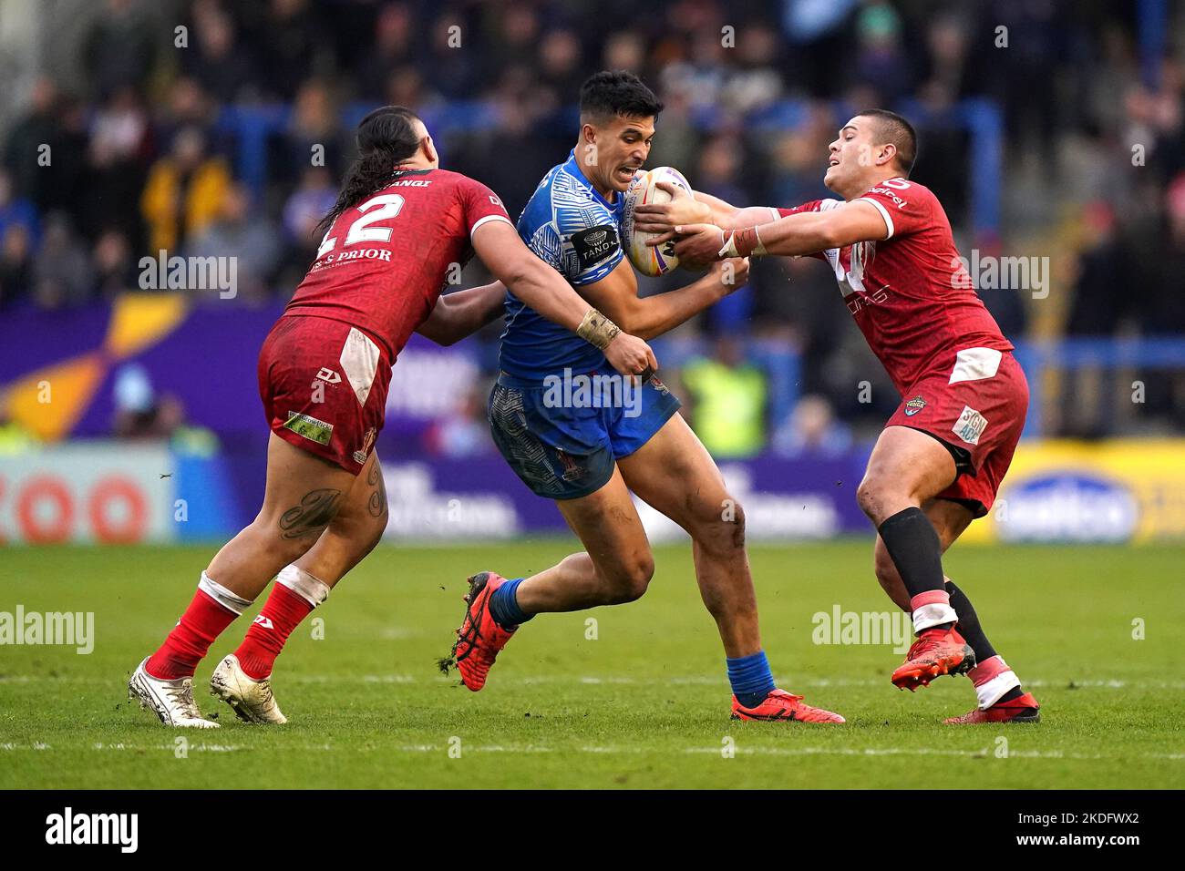Samoa's Joseph Suaali'i (centre) is tackled by Tonga's Keaon ...