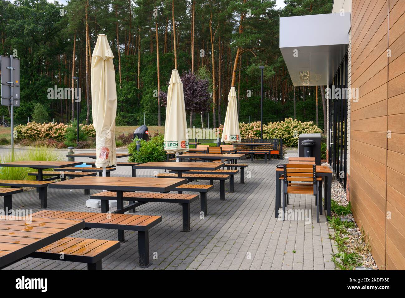 Otloczyn, Poland - September 11, 2022: Tables and benches outside the King Burger restaurant in ...