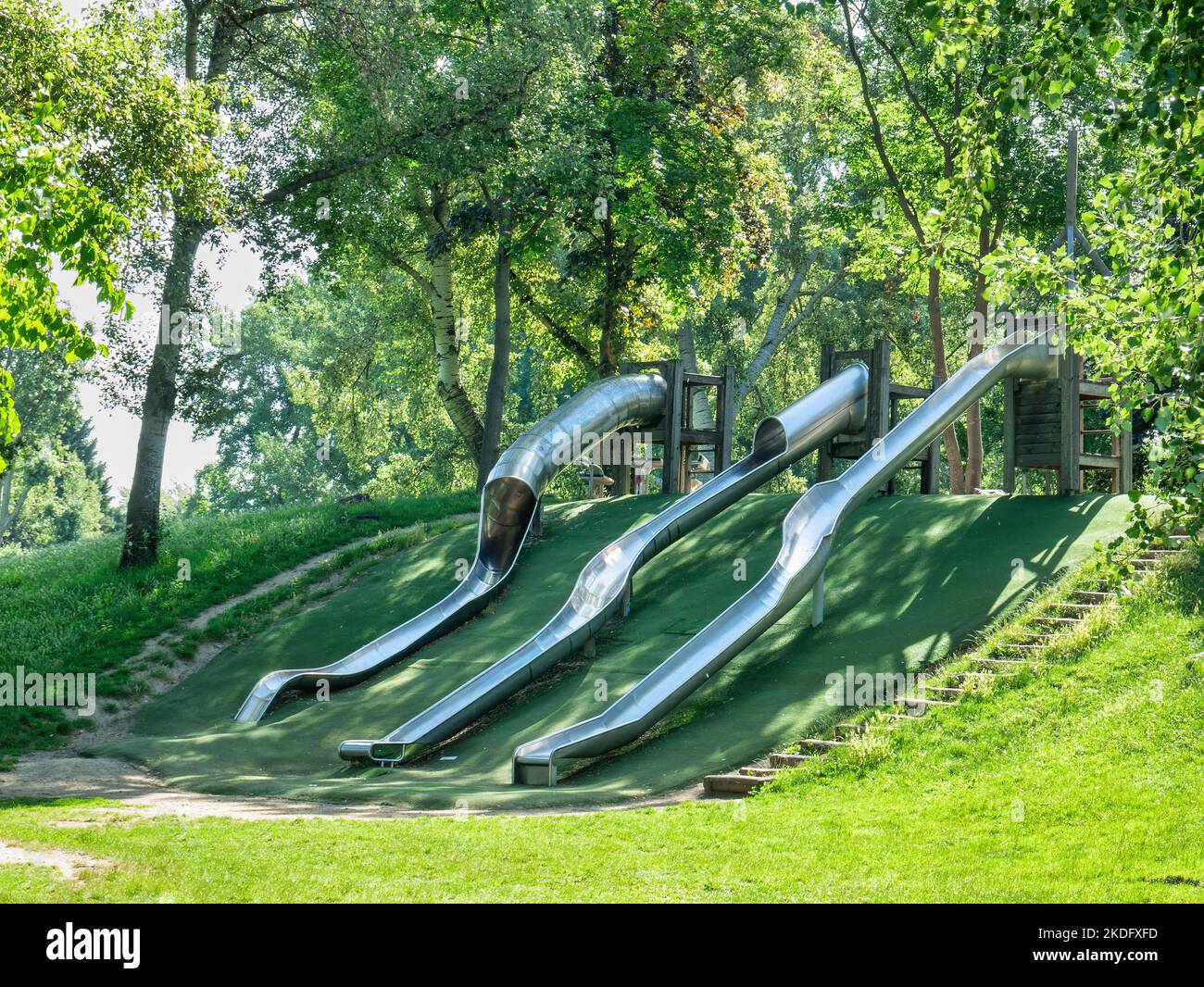 Three metal slides on a kids playground located in Donau Park Vienna ...
