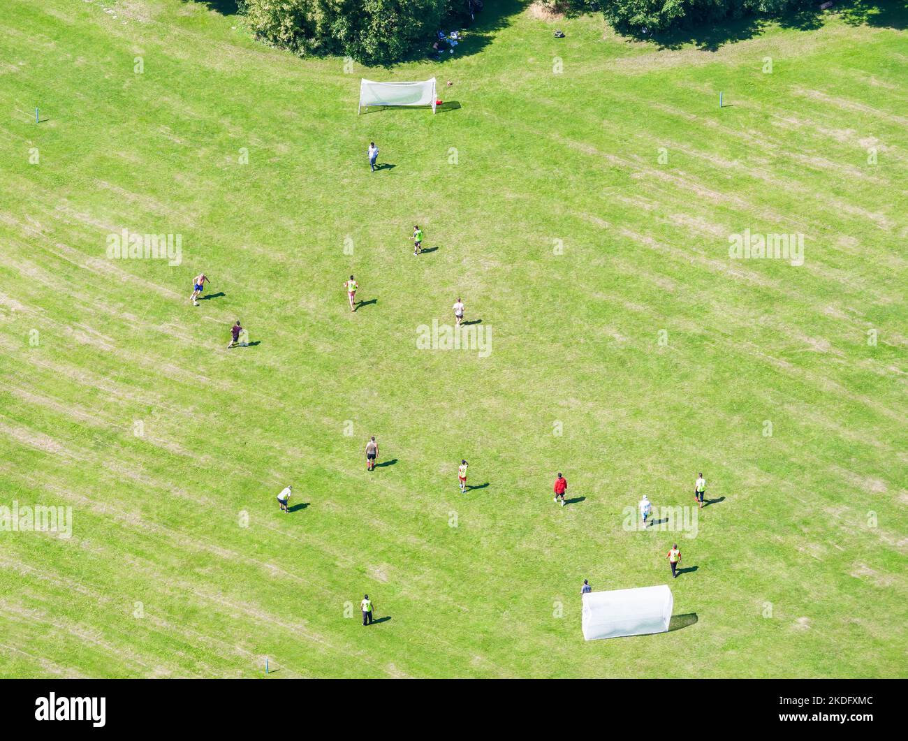 Aerial view with a football field. Two teams playing football on the ...