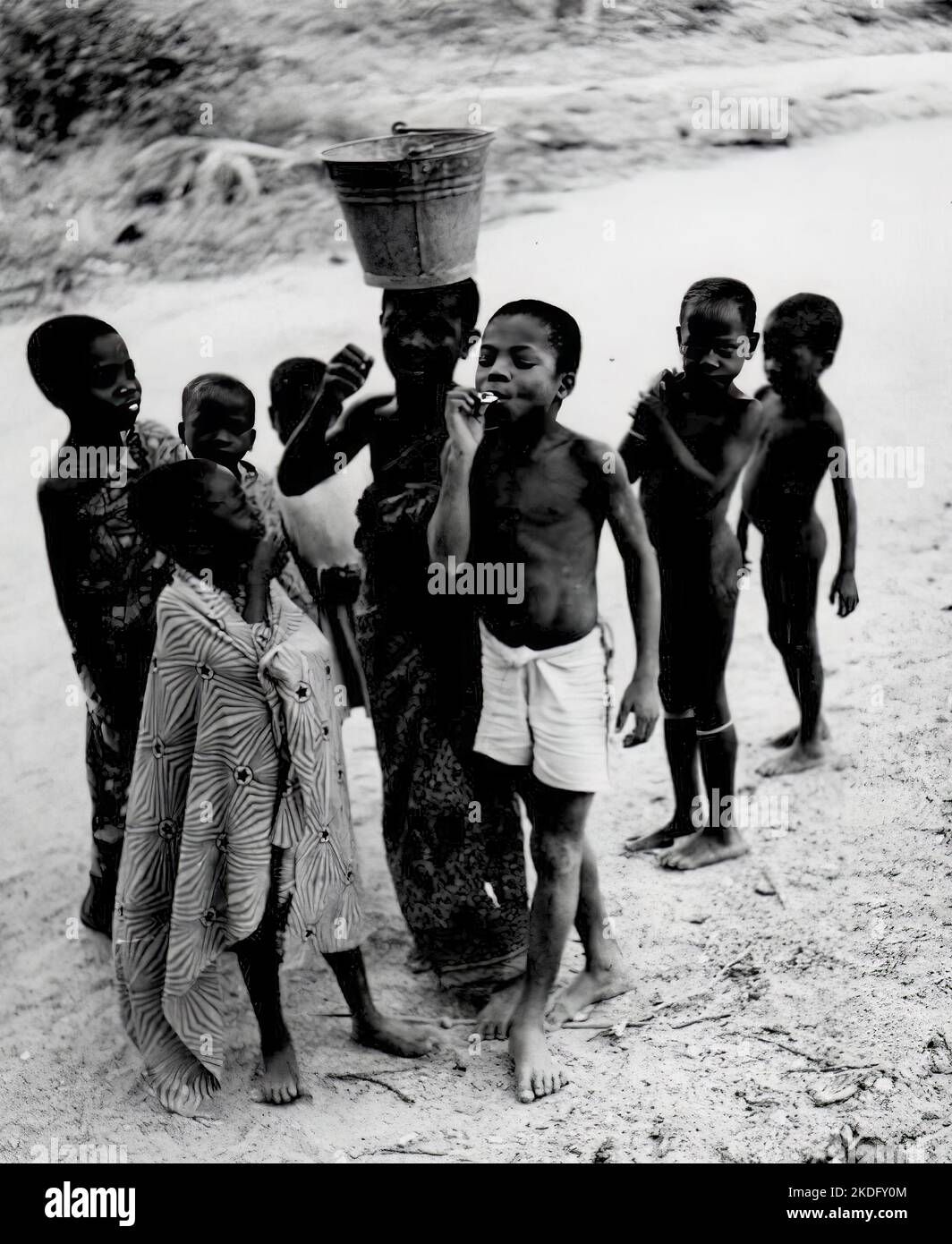 A child smoking a cigarette with a group of friends near Axim in Ghana ...