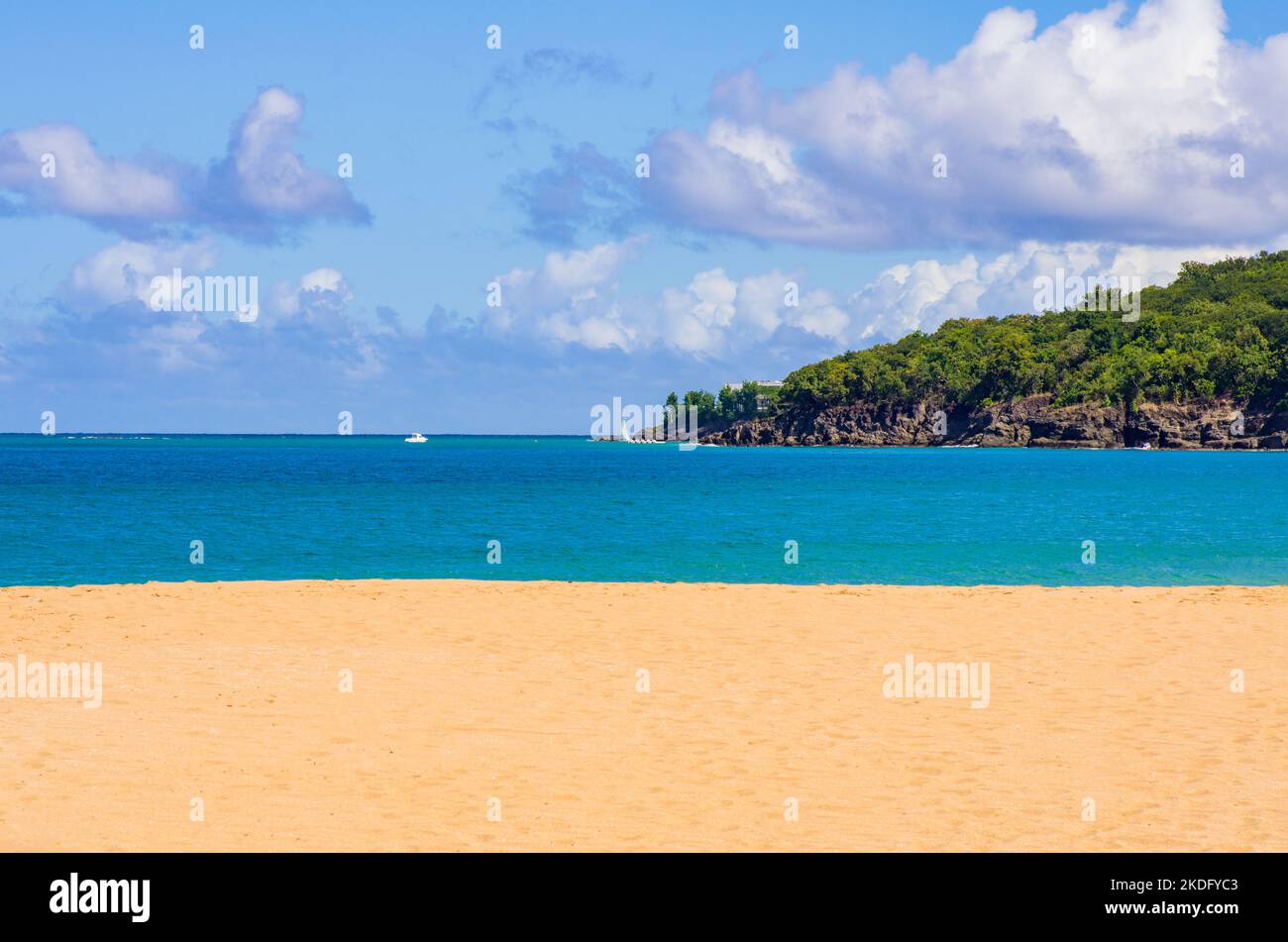 Wonderful view over the golden beach over the blue sea to white boats ...