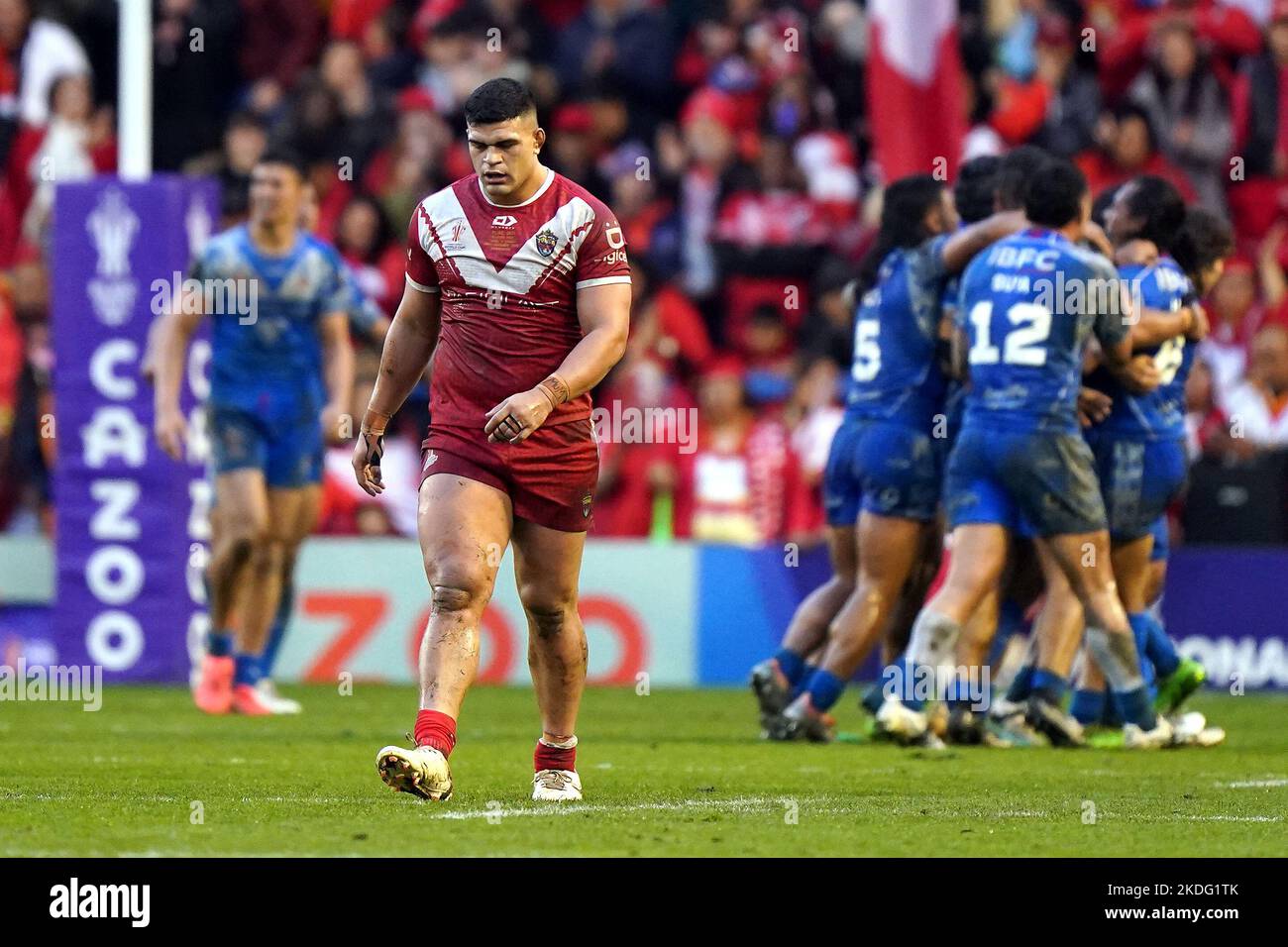 Tonga's David Fifita (left) looks dejected as Samoa players celebrate ...