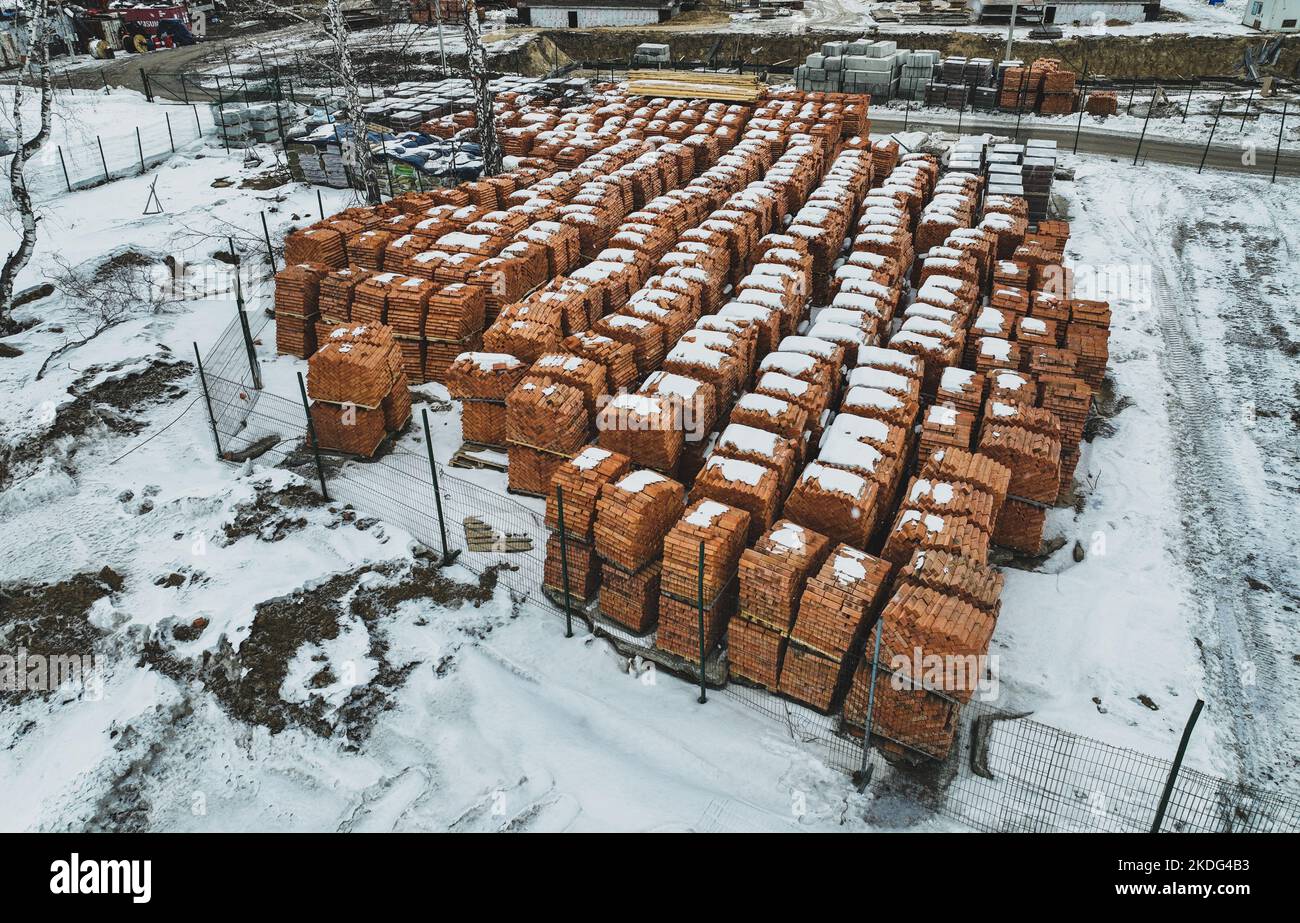 Pallets of bricks for construction. Outdoor storage in winter ...