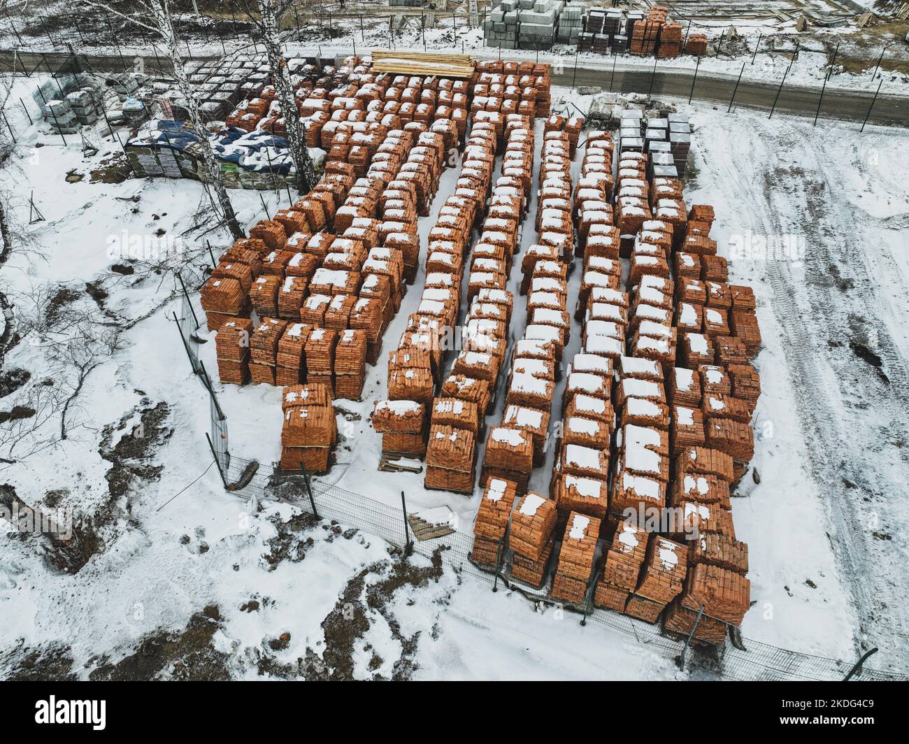 Pallets of bricks for construction. Outdoor storage in winter ...