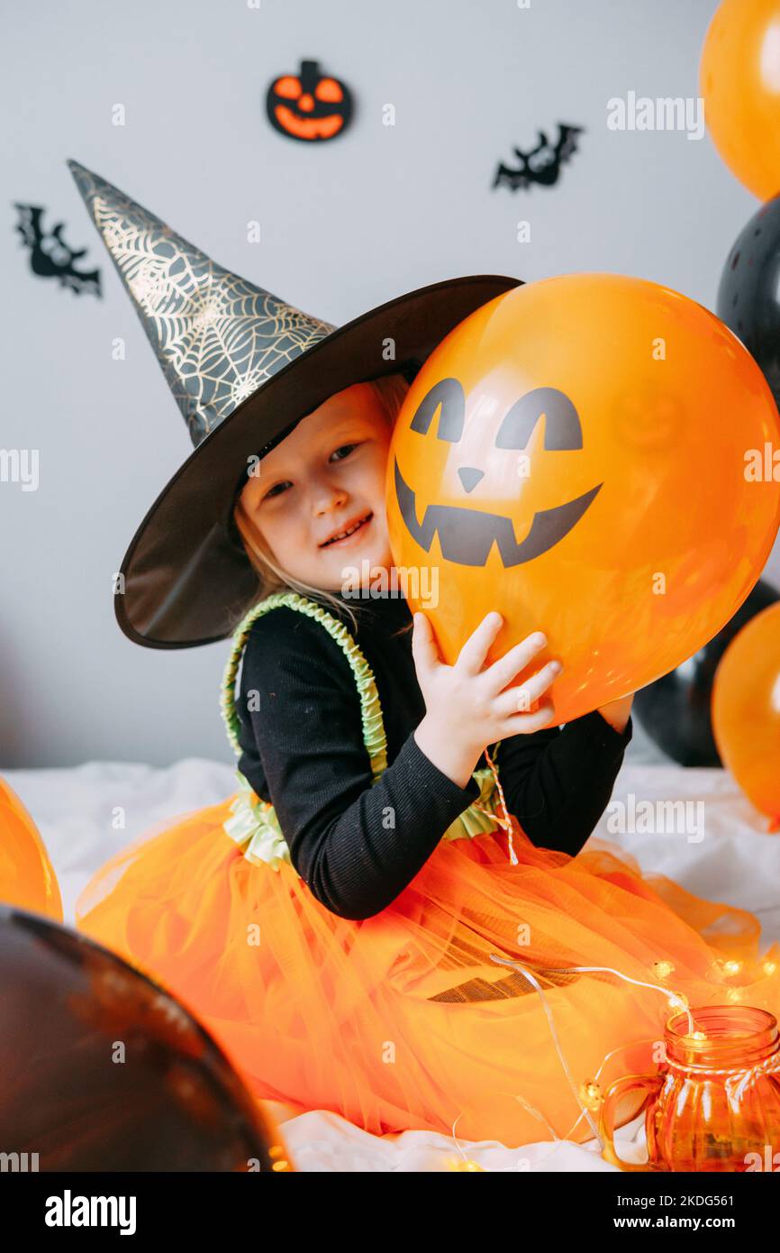Children's Halloween - a girl in a witch hat and a carnival costume ...