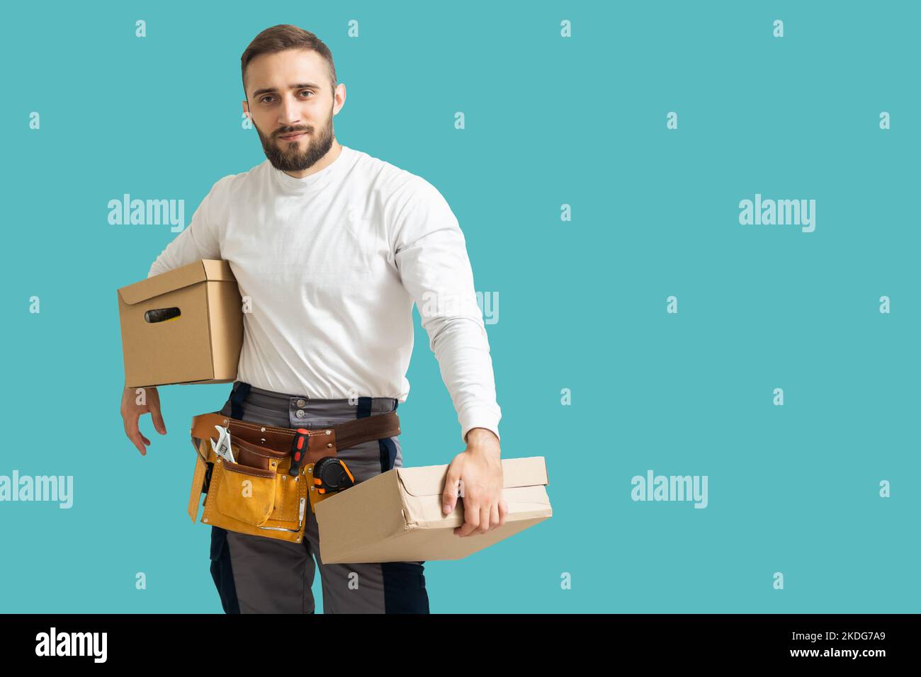 Portrait of a worker with tool and boxes Stock Photo - Alamy