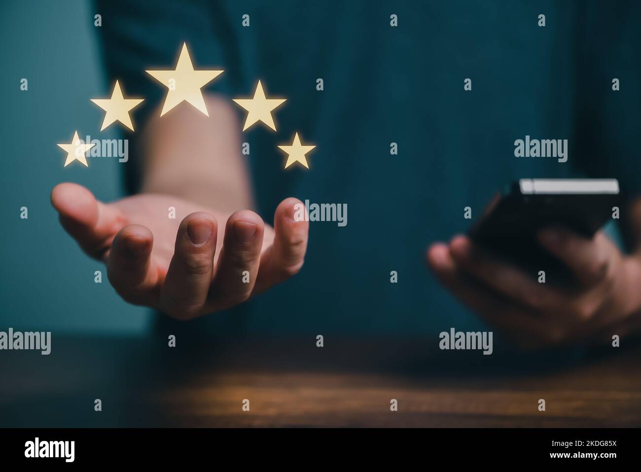 Young man using smartphone giving positive five stars rating review for ... Young man using smartphone giving positive five stars rating review for ...