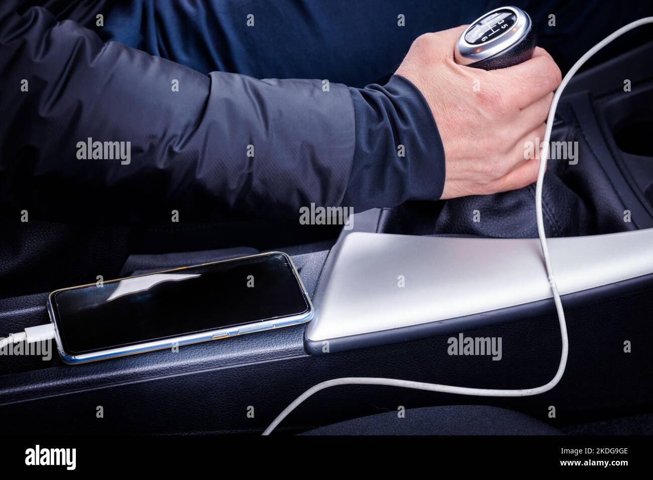 charging the phone in the car. A smartphone connected to a charger and ...